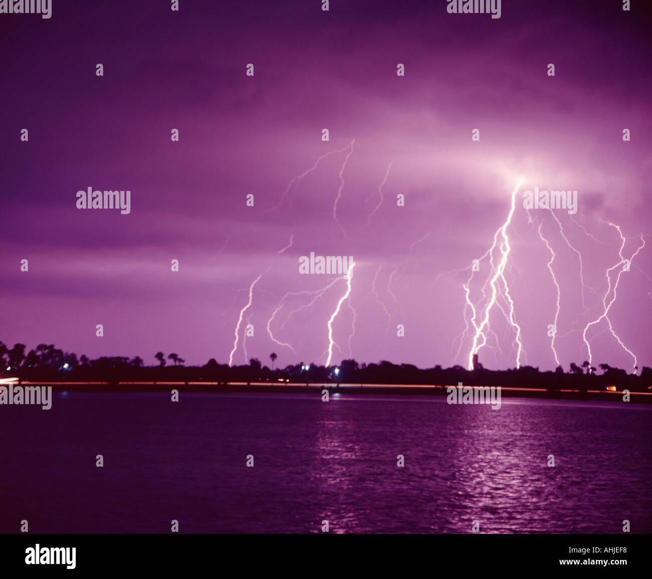 multiple lightning strikes reflected in water Stock Photo - Alamy