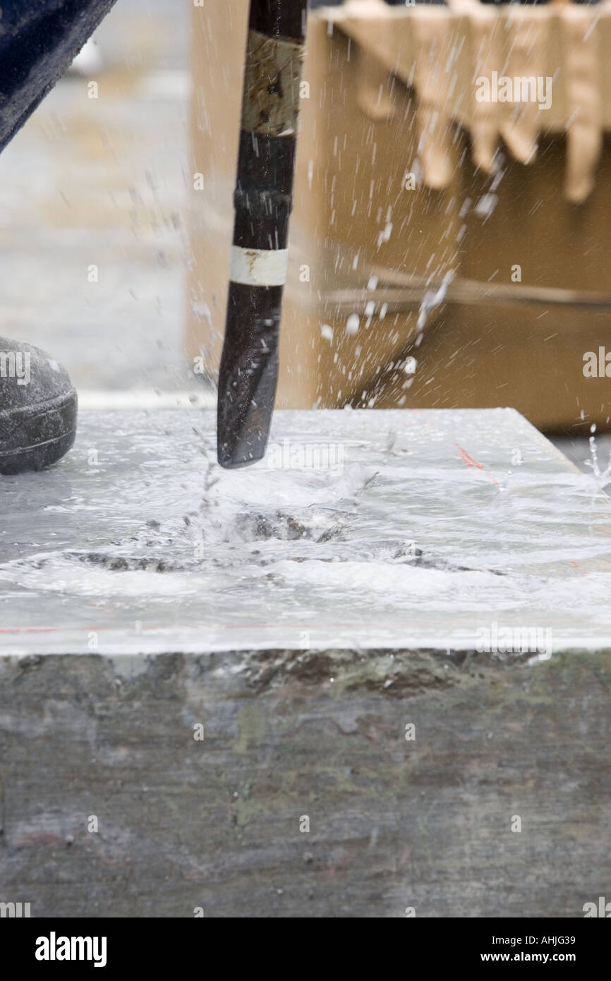 Water cools an iron rod as it is used to chip through a solid granite ...