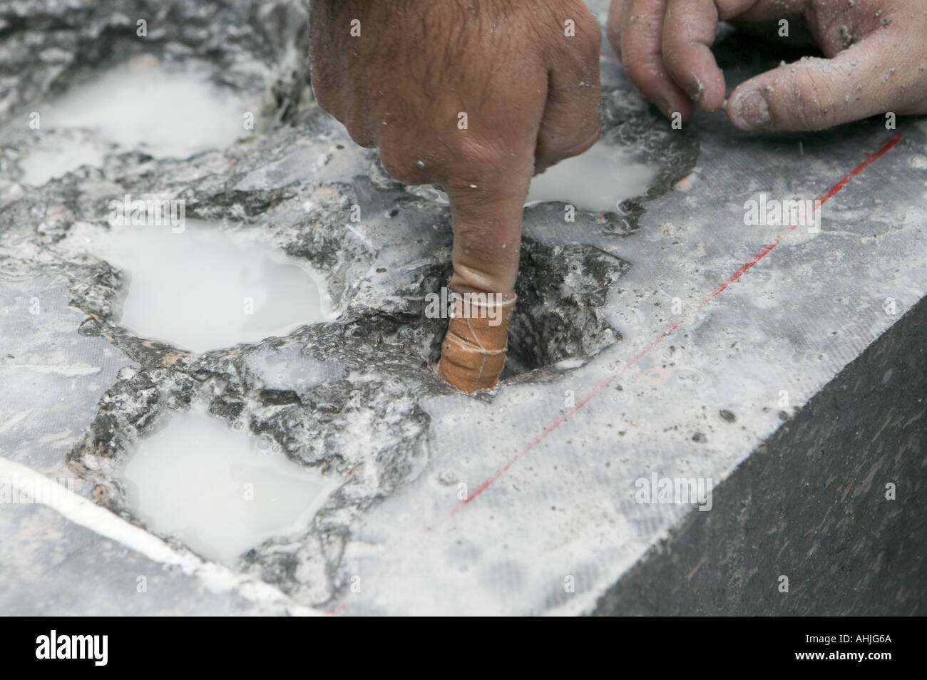 Judges measures depth of holes in granite block during Basque Games ...