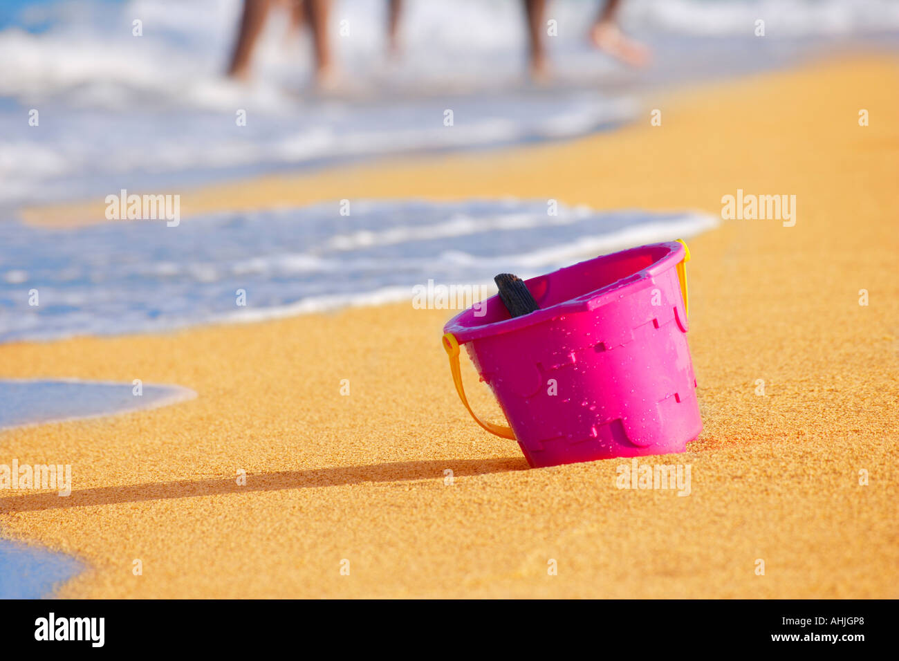 Bucket in the sand Stock Photo - Alamy
