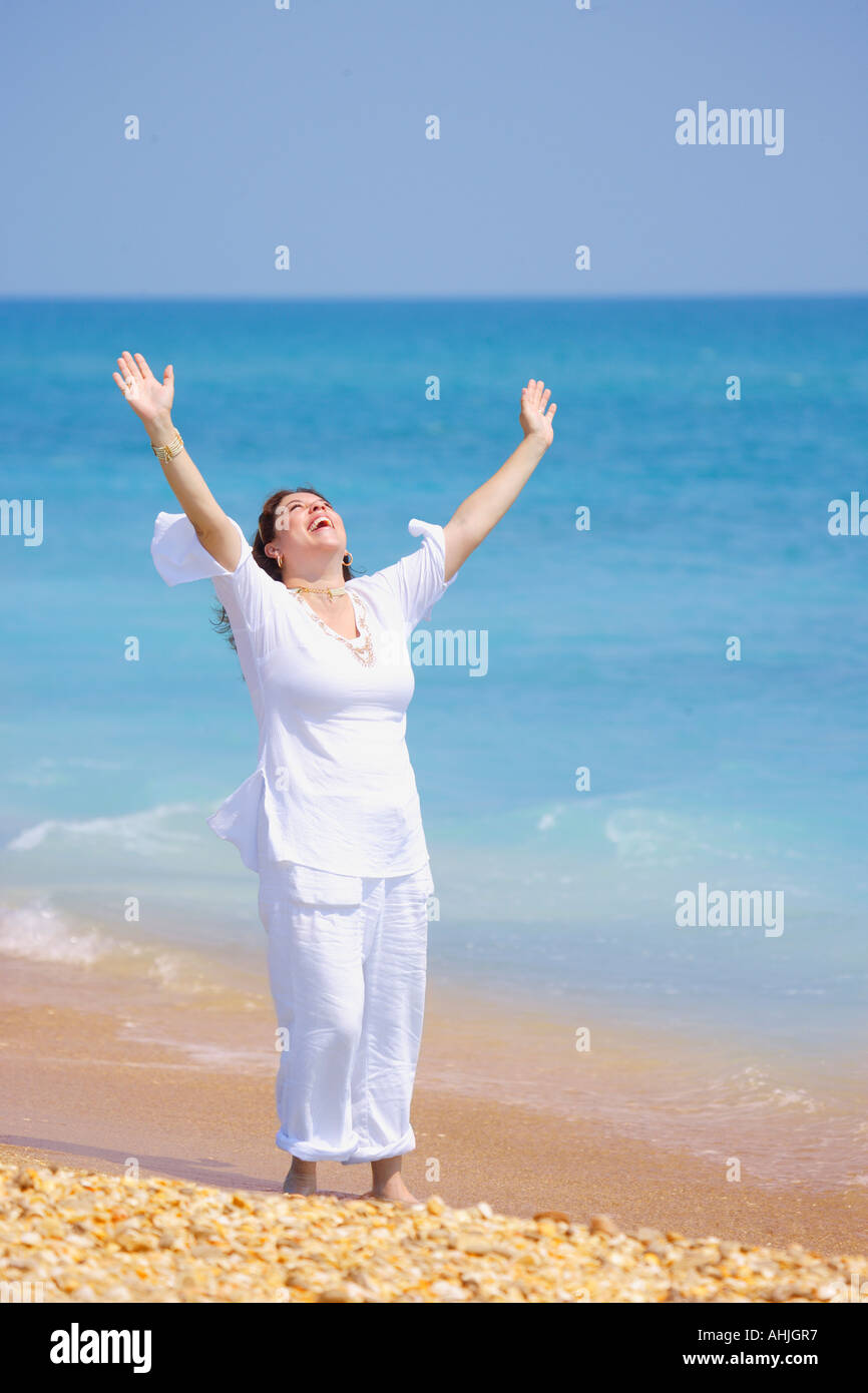 Woman with her arms raised Stock Photo - Alamy