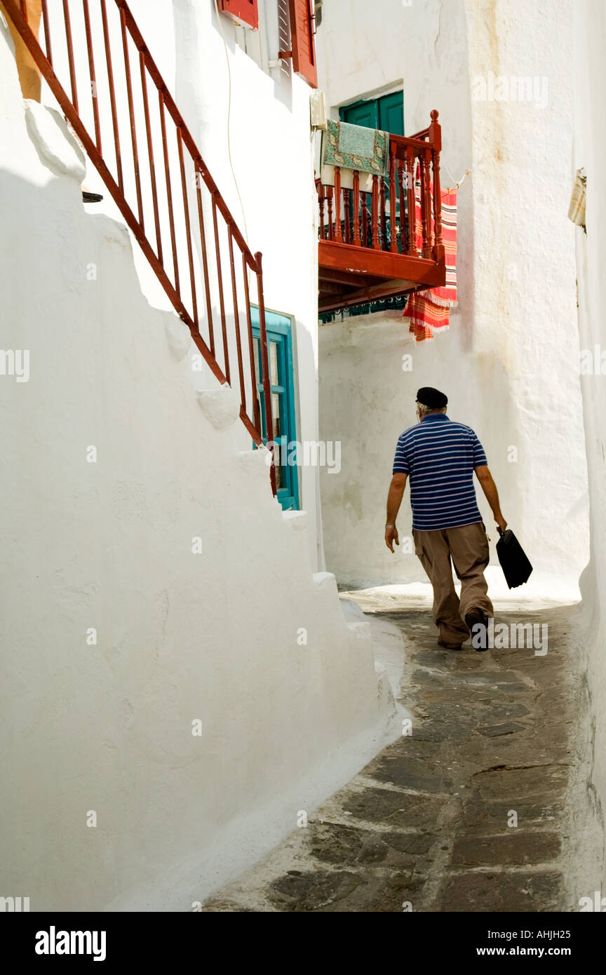 Local Greek man walking working in alley alleyway Mykonos Town Mykonos ...