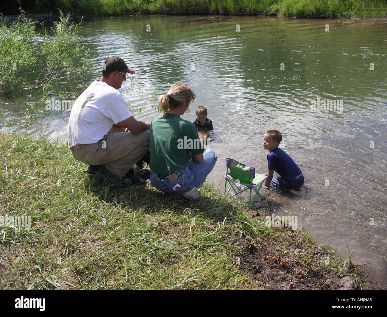 Family Playing by River Stock Photo - Alamy