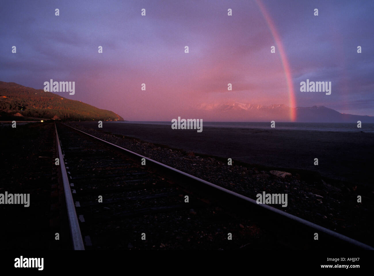 USA Alaska Chugach State Park Rainbow over railroad tracks as storm ...