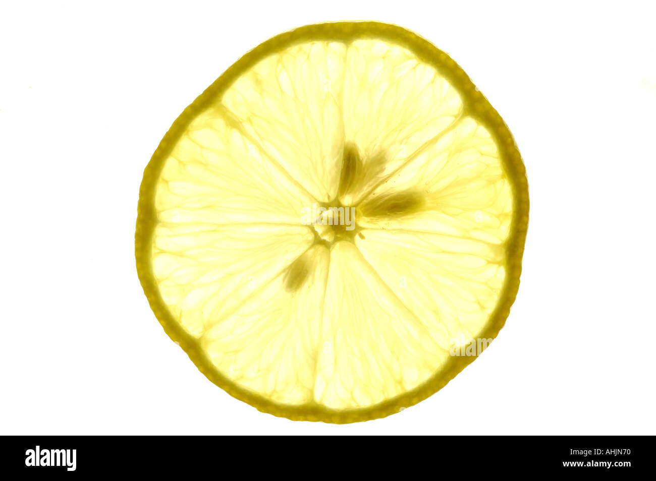 Slice of lemon back lit on white background Stock Photo - Alamy