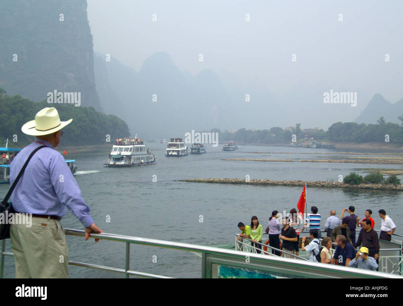 tourist watching boat convoy on the Li River Stock Photo - Alamy
