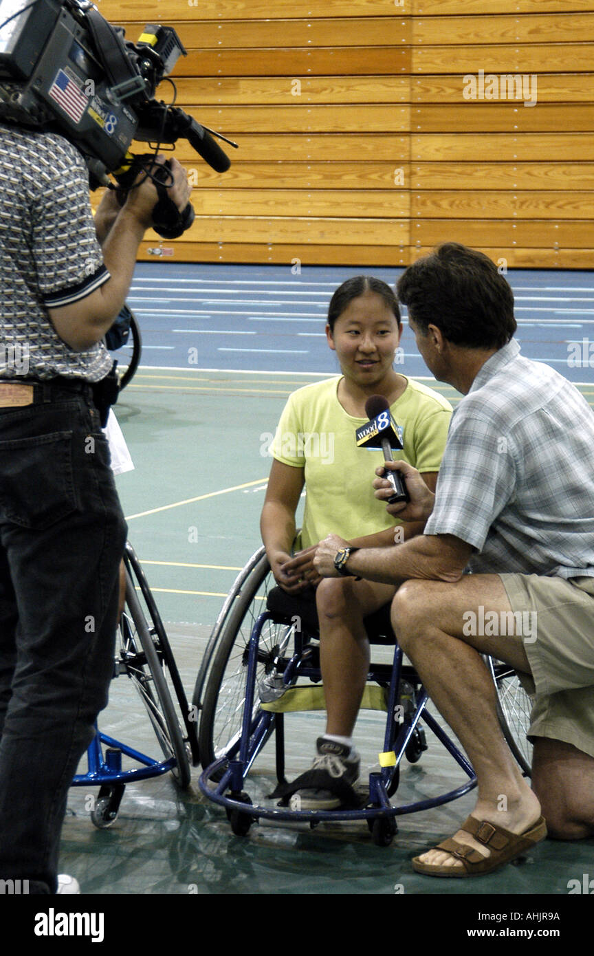 Teenaged asian-american girl being interviewed by television station ...