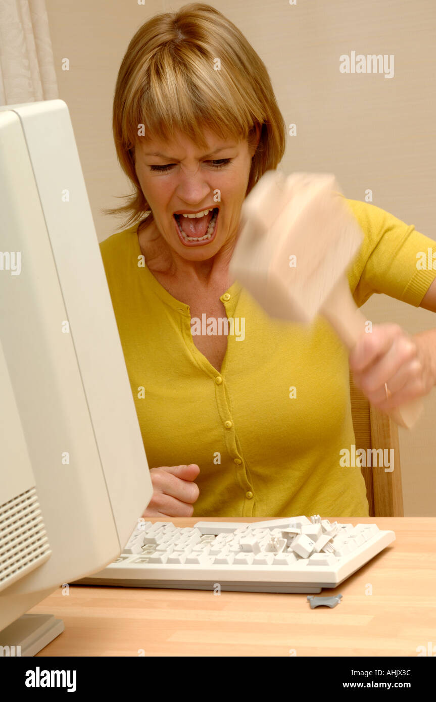 Woman with computer rage Stock Photo - Alamy