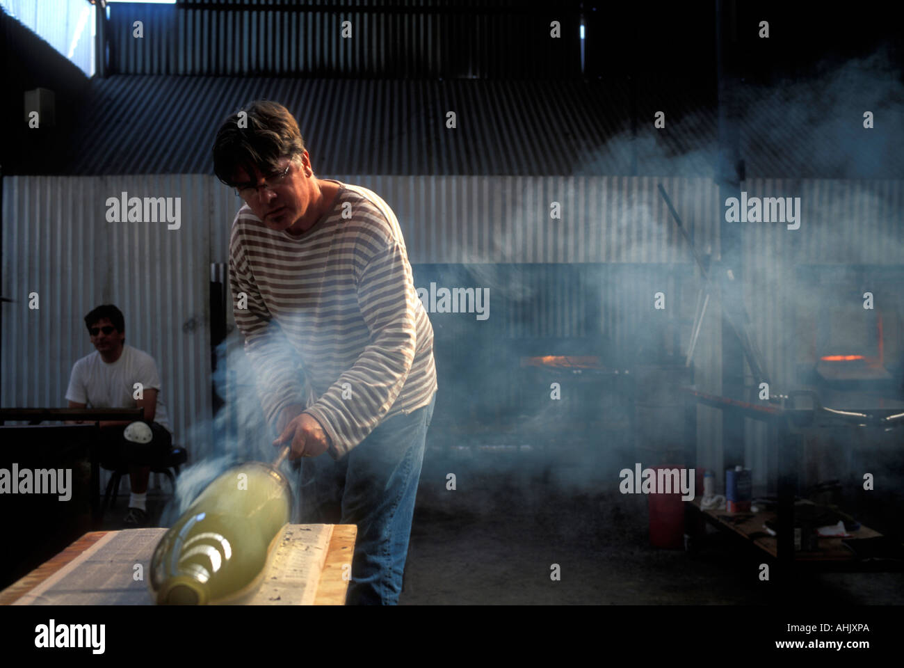 USA Washington Seattle Benjamin Moore works with red hot glass at glass ...