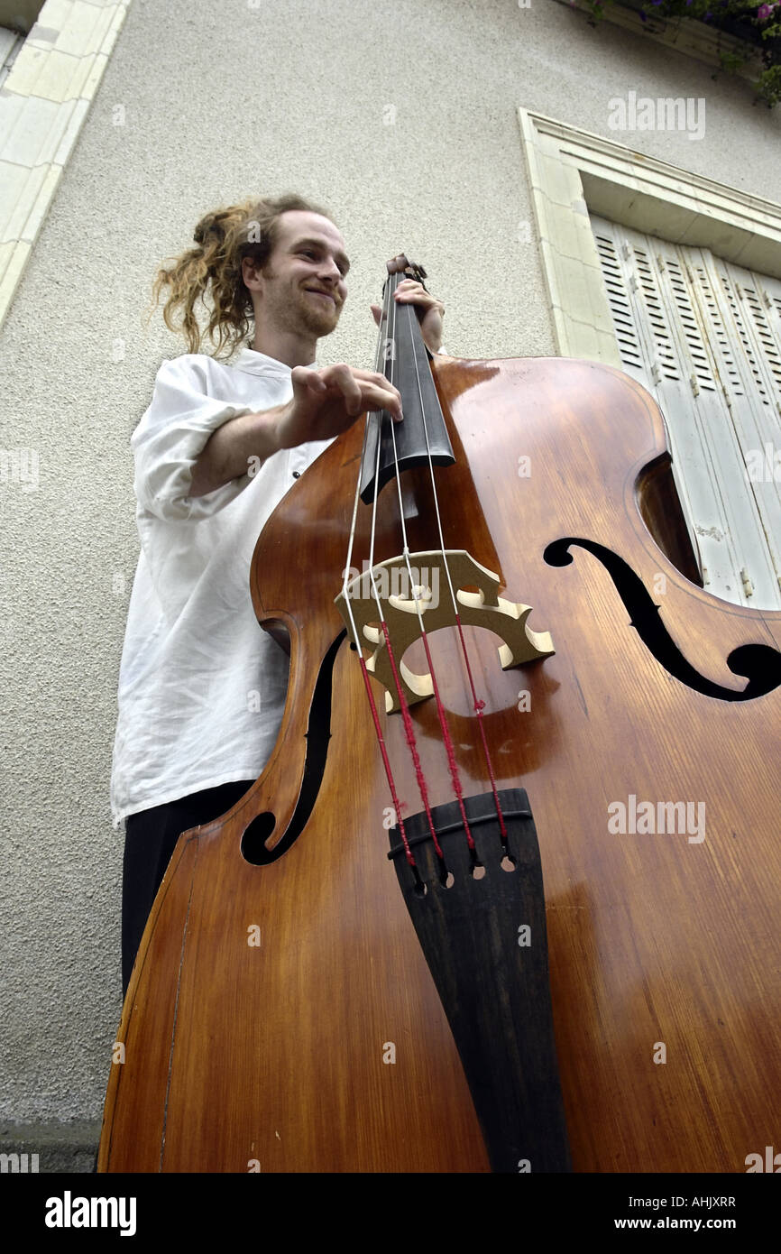 Low angle shot of a young bass player playing in the street Stock Photo ...