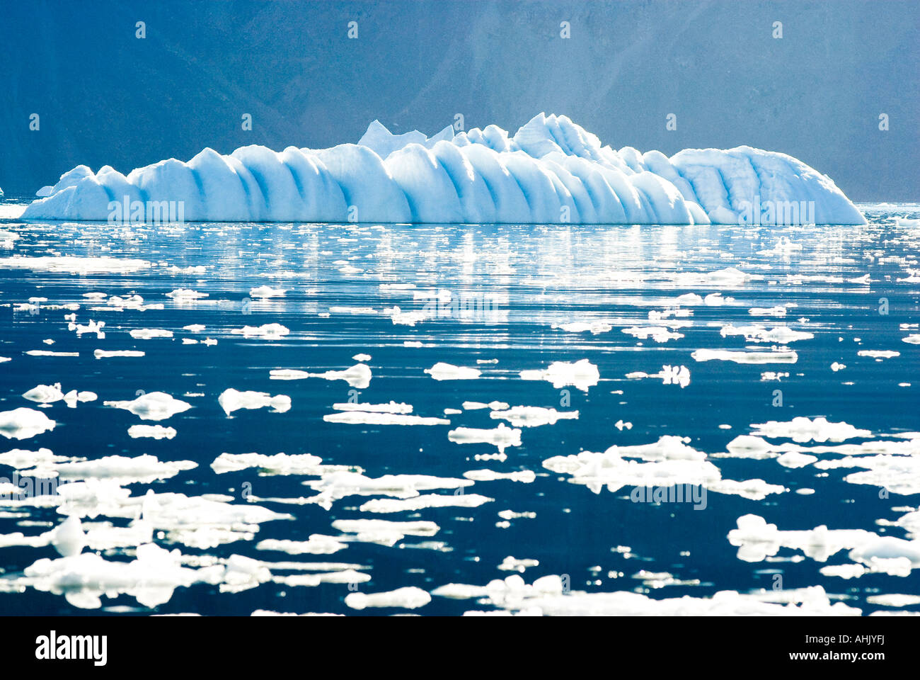 Blue iceberg floating in pack ice Inglefield Fjord near Qaanaaq ...