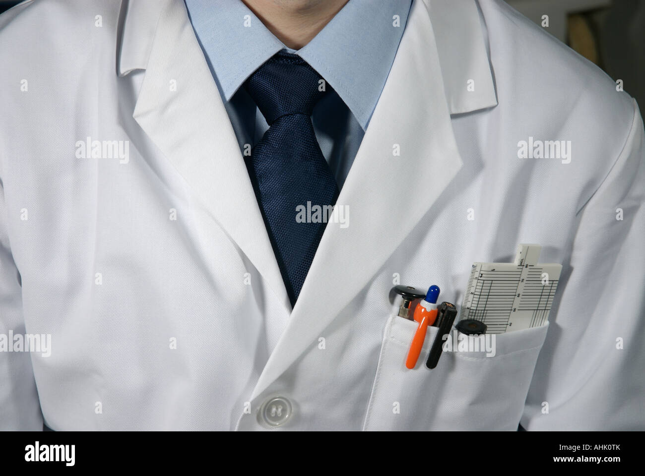 Image of a laboratory worker in a white coat with pens and a ruler in ...