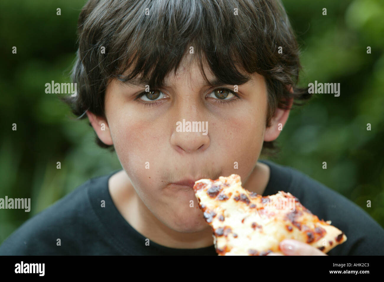 Teenager boy eating pizza hi-res stock photography and images - Alamy