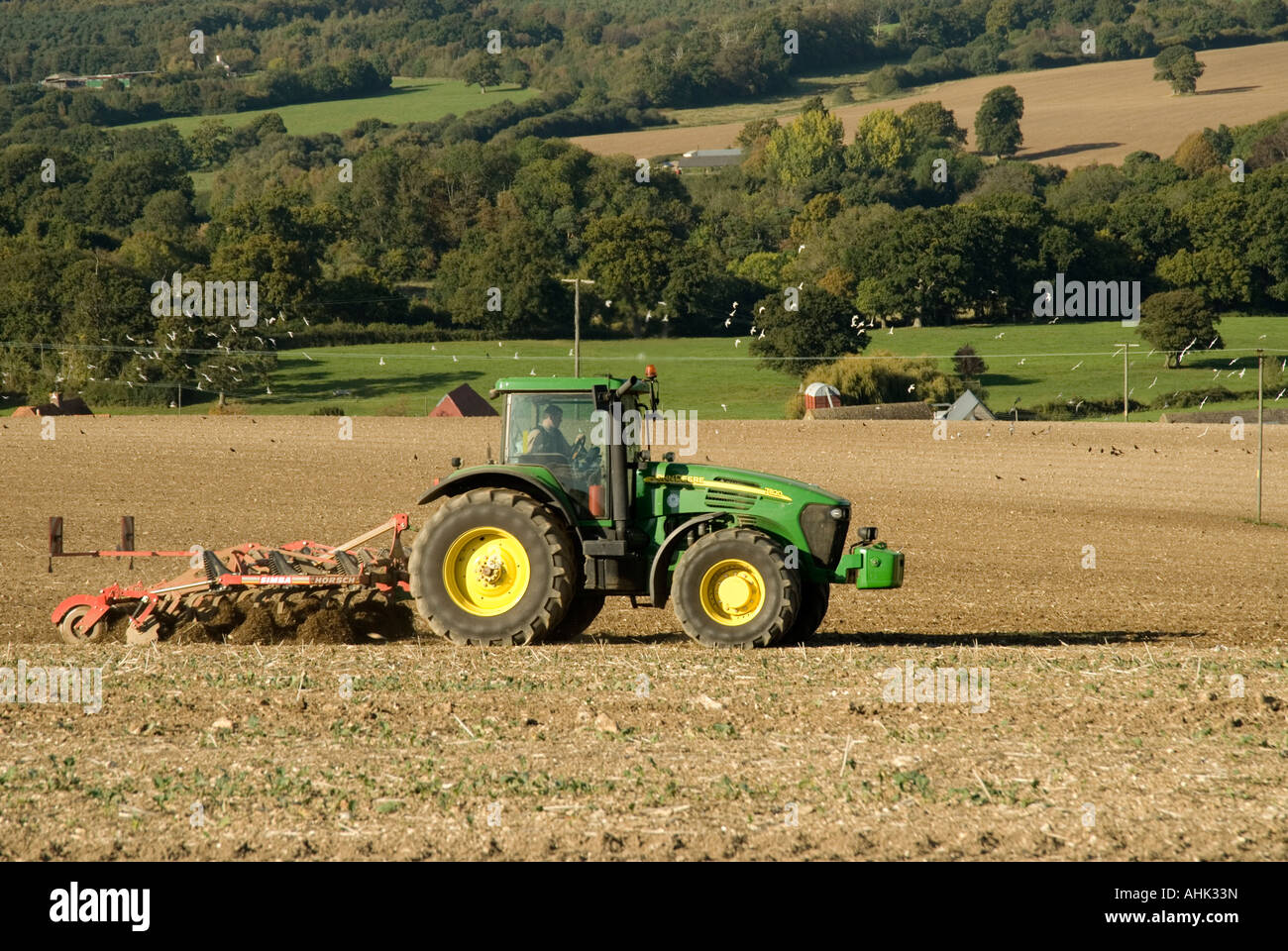 Tractor ploughing a field Stock Photo - Alamy