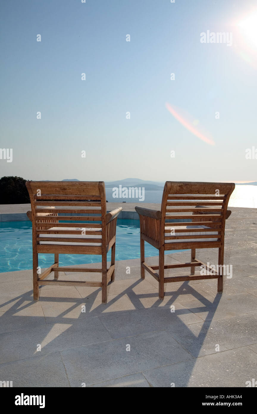 2 chairs by pool view of islands Stock Photo - Alamy