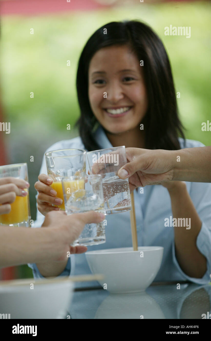 Asian woman eating using chopsticks Stock Photo - Alamy