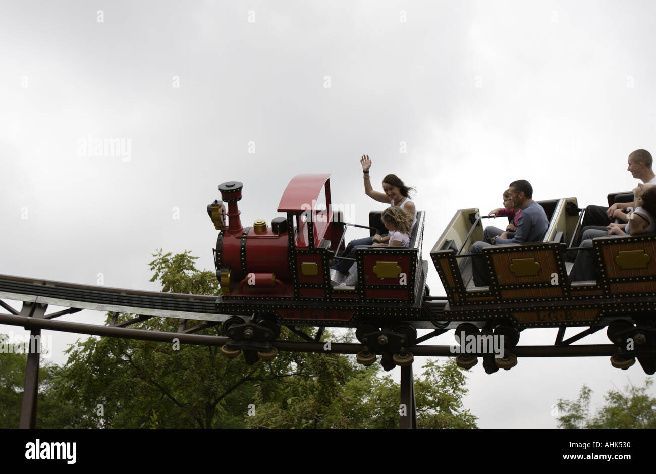 Family at amusement park action amusement park ride locomotive rides ...