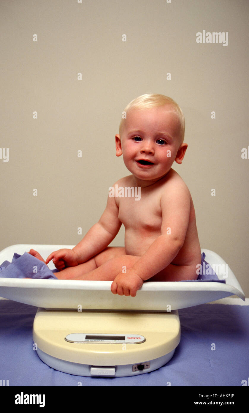 young baby around 6 months sitting in weighing scales Stock Photo - Alamy