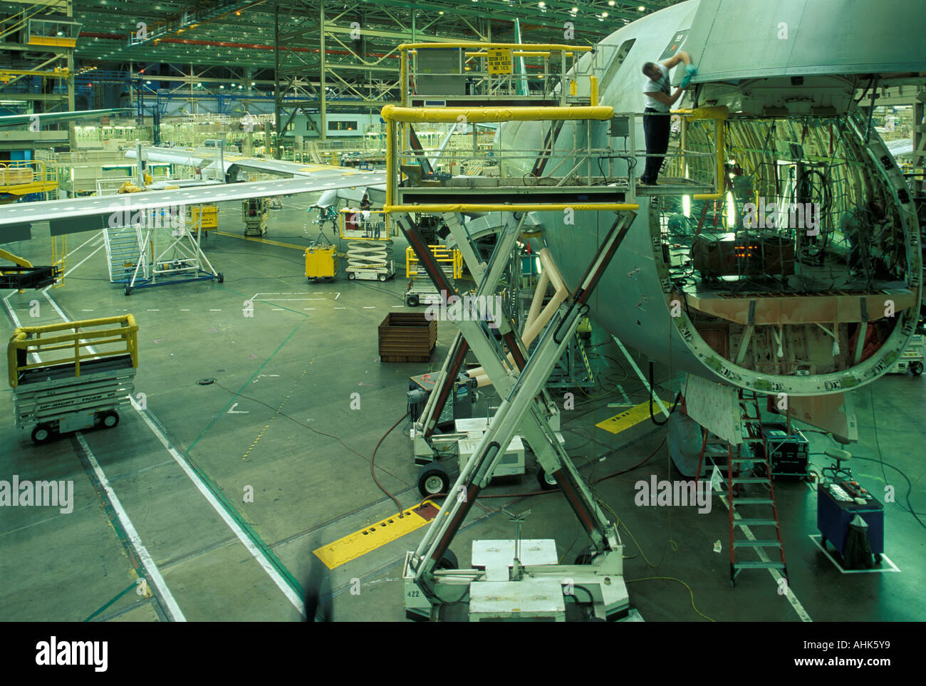 USA Washington Everett Boeing worker inserts rivets into upturned nose ...