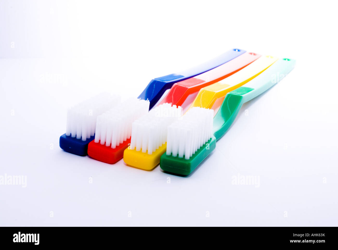 Four coloured toothbrushes Stock Photo - Alamy