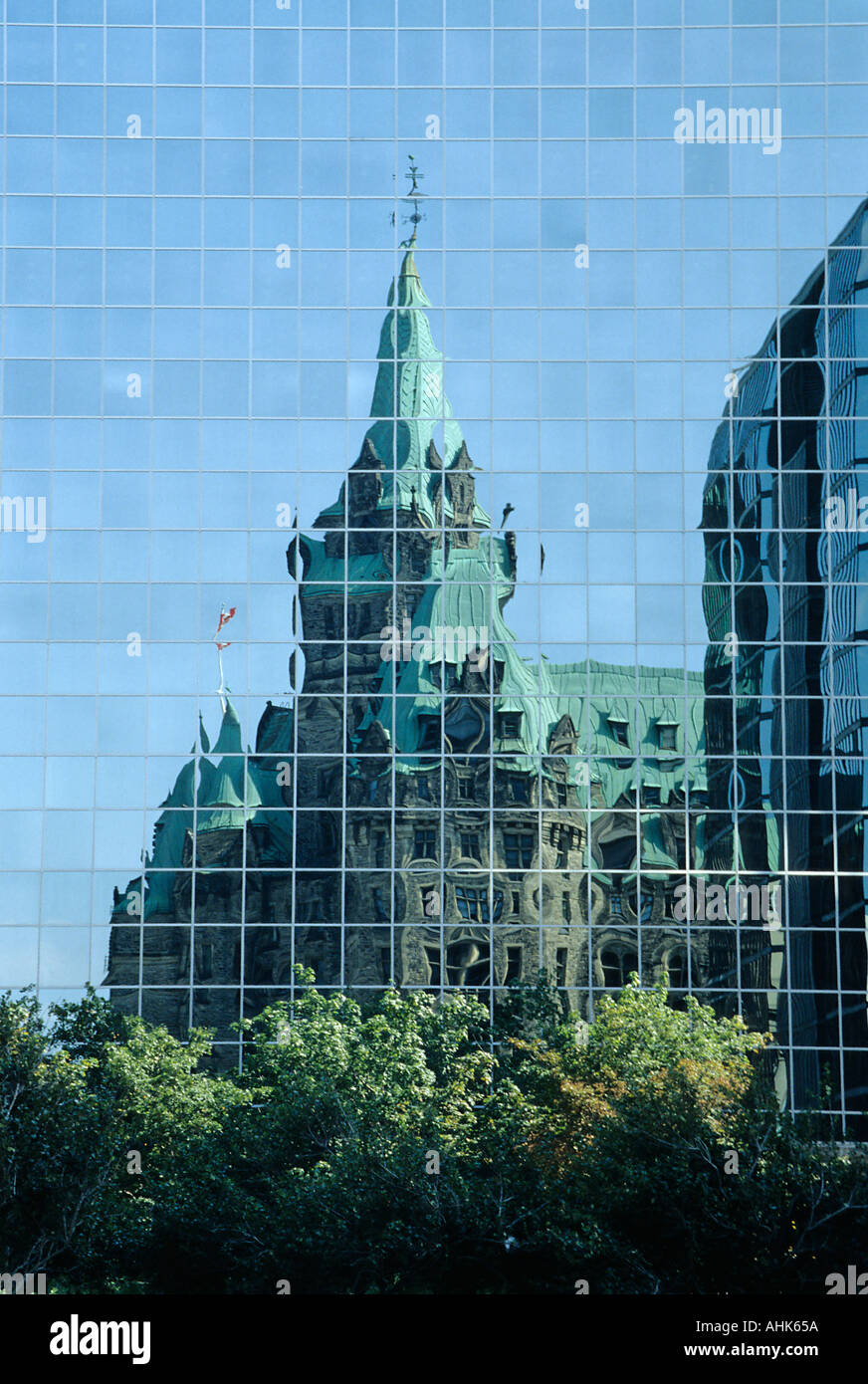 Town hall of Montreal reflected in the front of an office building ...