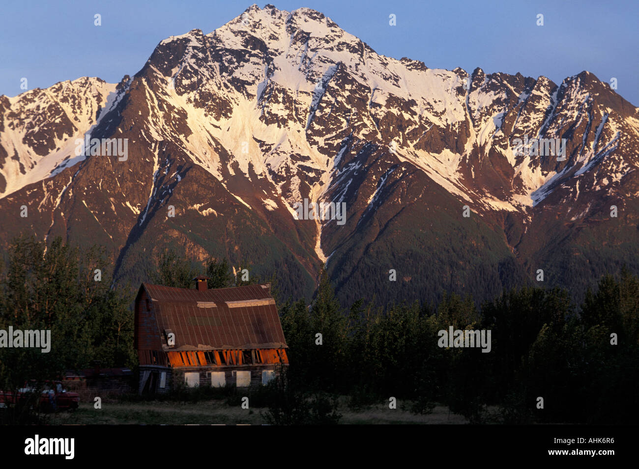 USA Alaska Old barn building at sunset under Pioneer Peak near ...