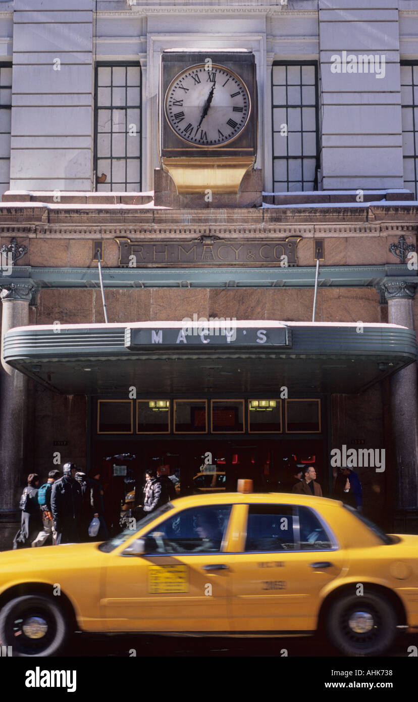 yellow taxi driving past Macys department store main entrance and Clock ...