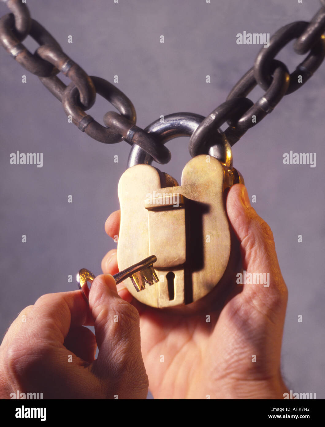 hands opening lock and chain Stock Photo - Alamy