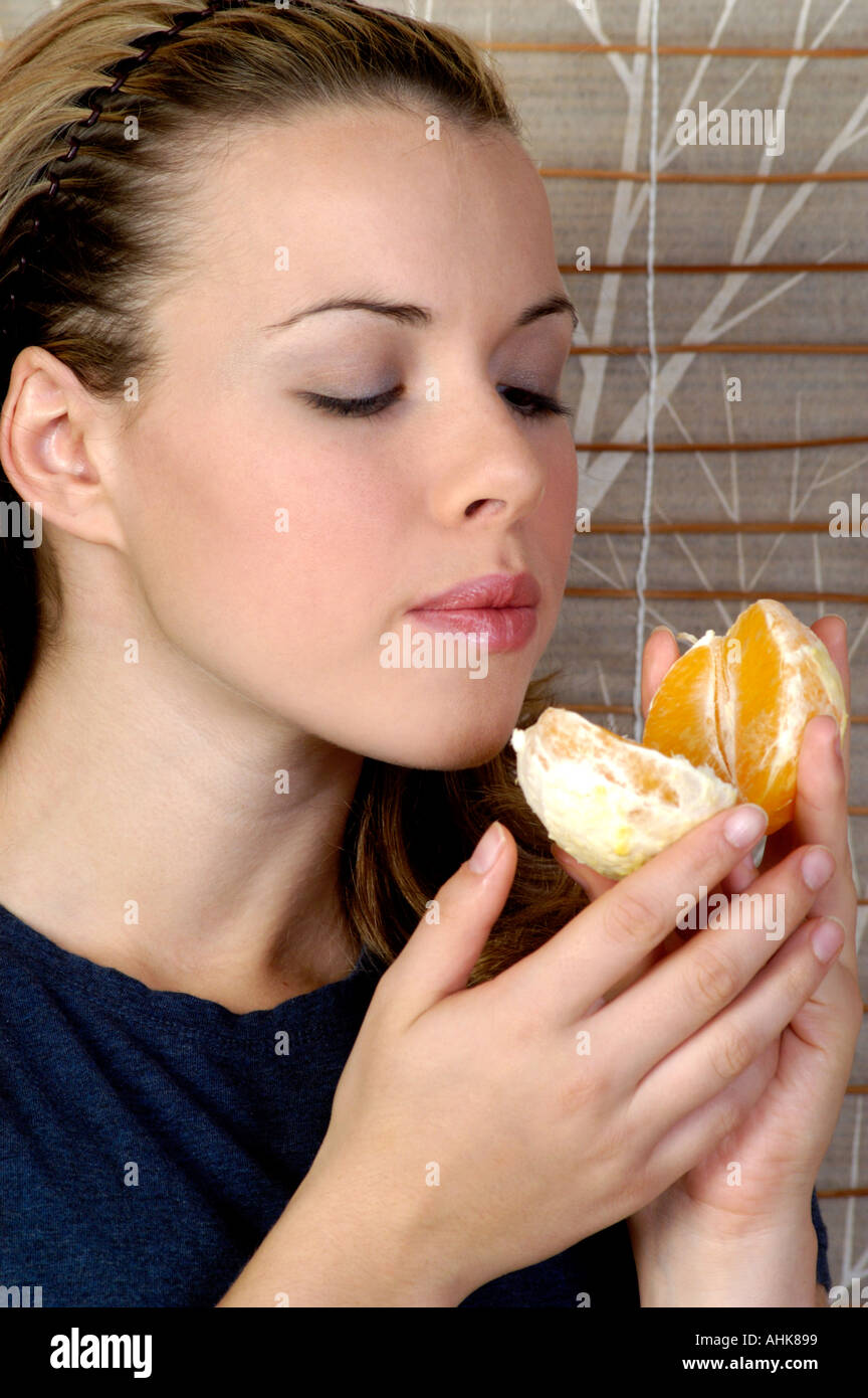Woman smelling orange fruit hi-res stock photography and images - Alamy