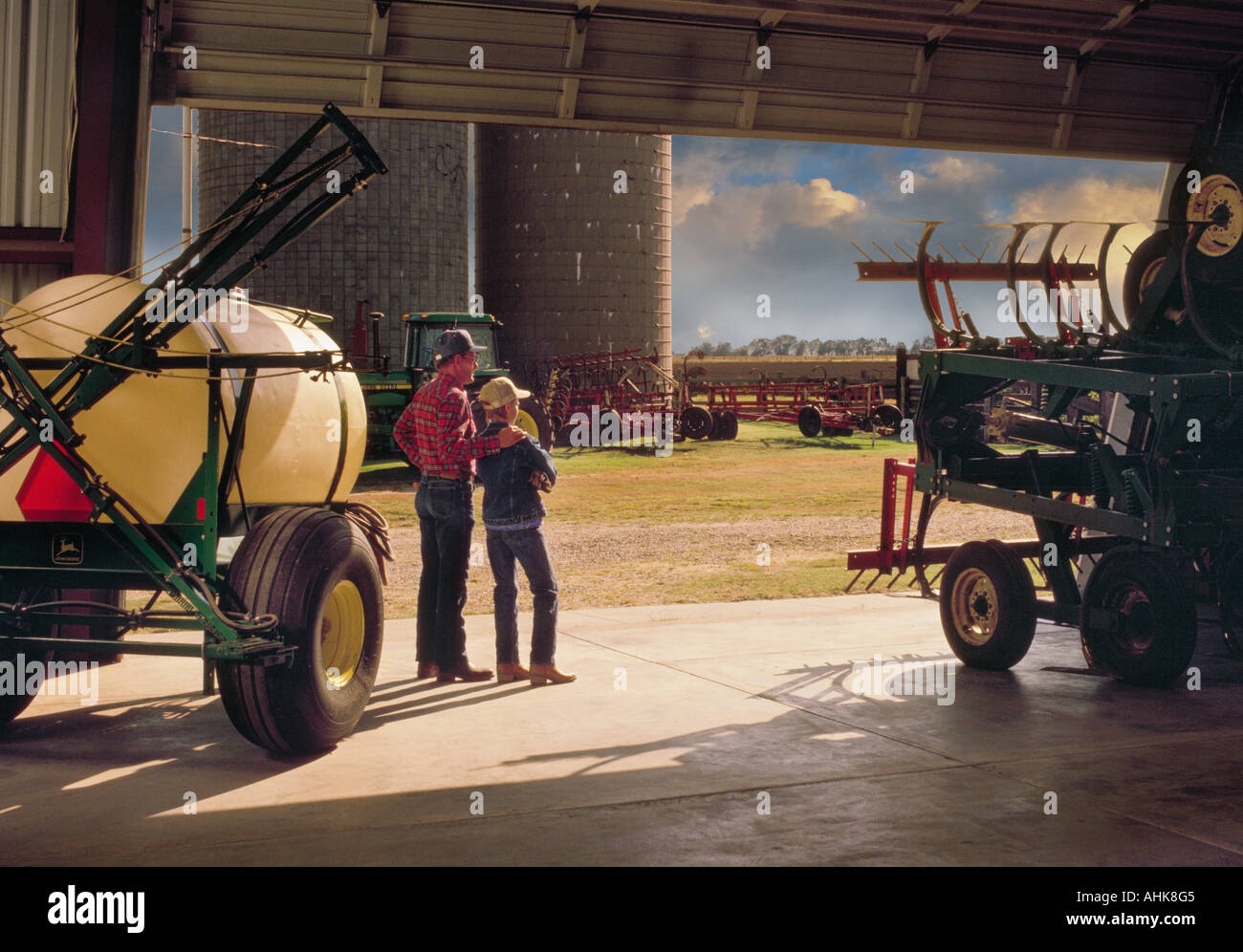 farmer with son at barn Stock Photo - Alamy