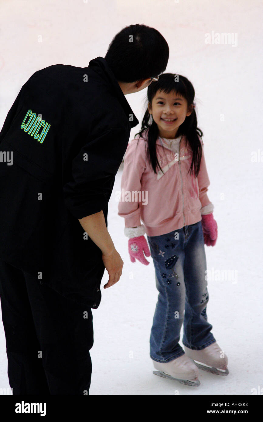 Coach Teaching a Young Girl Skating on an Ice Rink Stock Photo - Alamy