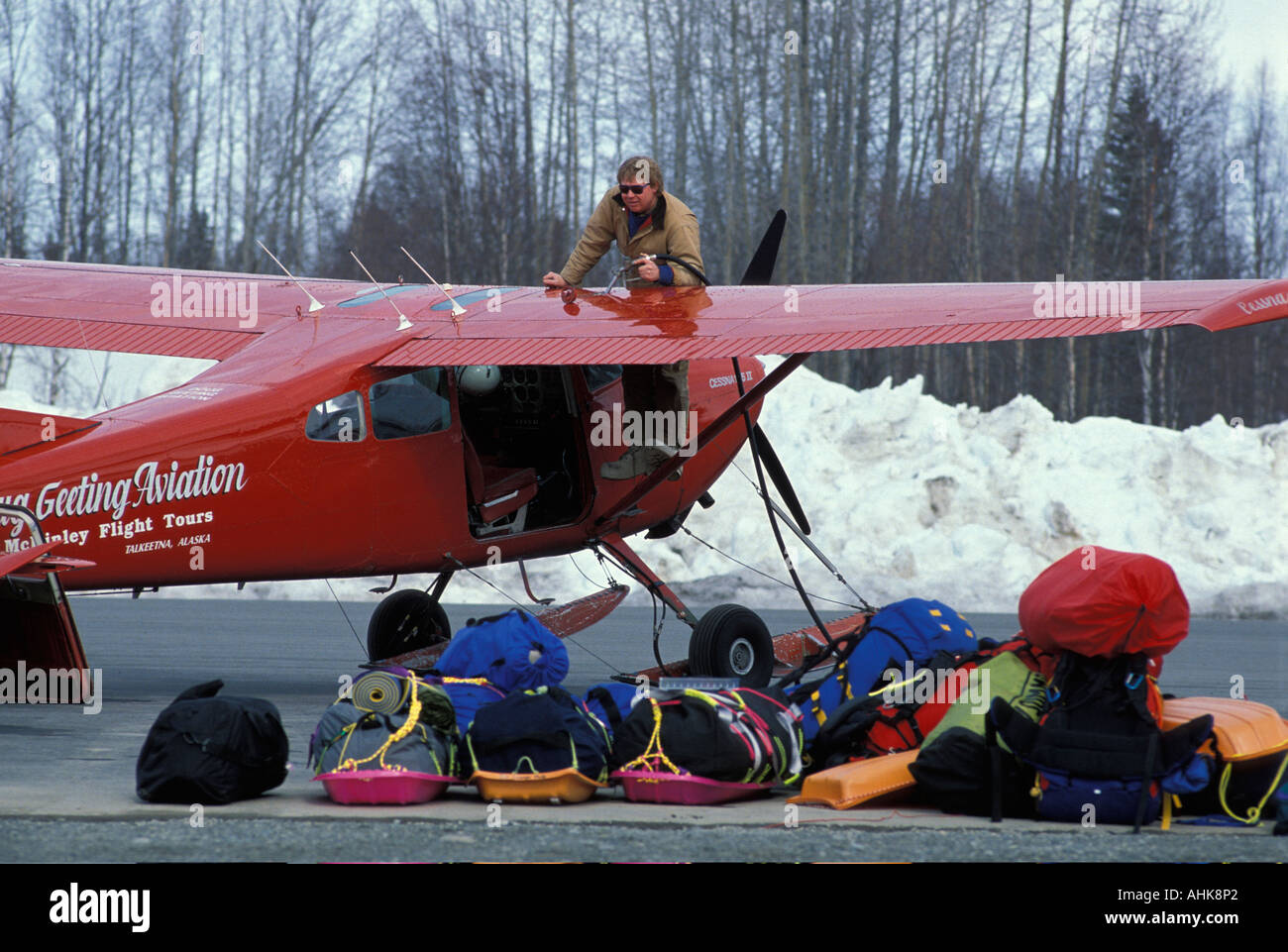 USA Alaska Glacier pilot Doug Geeting tops off gas tanks of Cessna ski ...