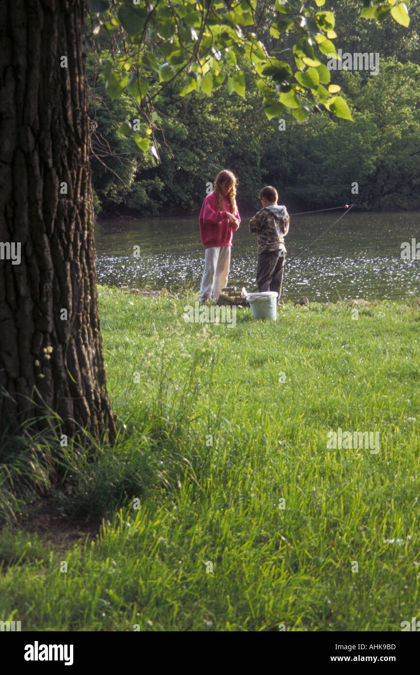 Boy fishing on riverbank hi-res stock photography and images - Alamy
