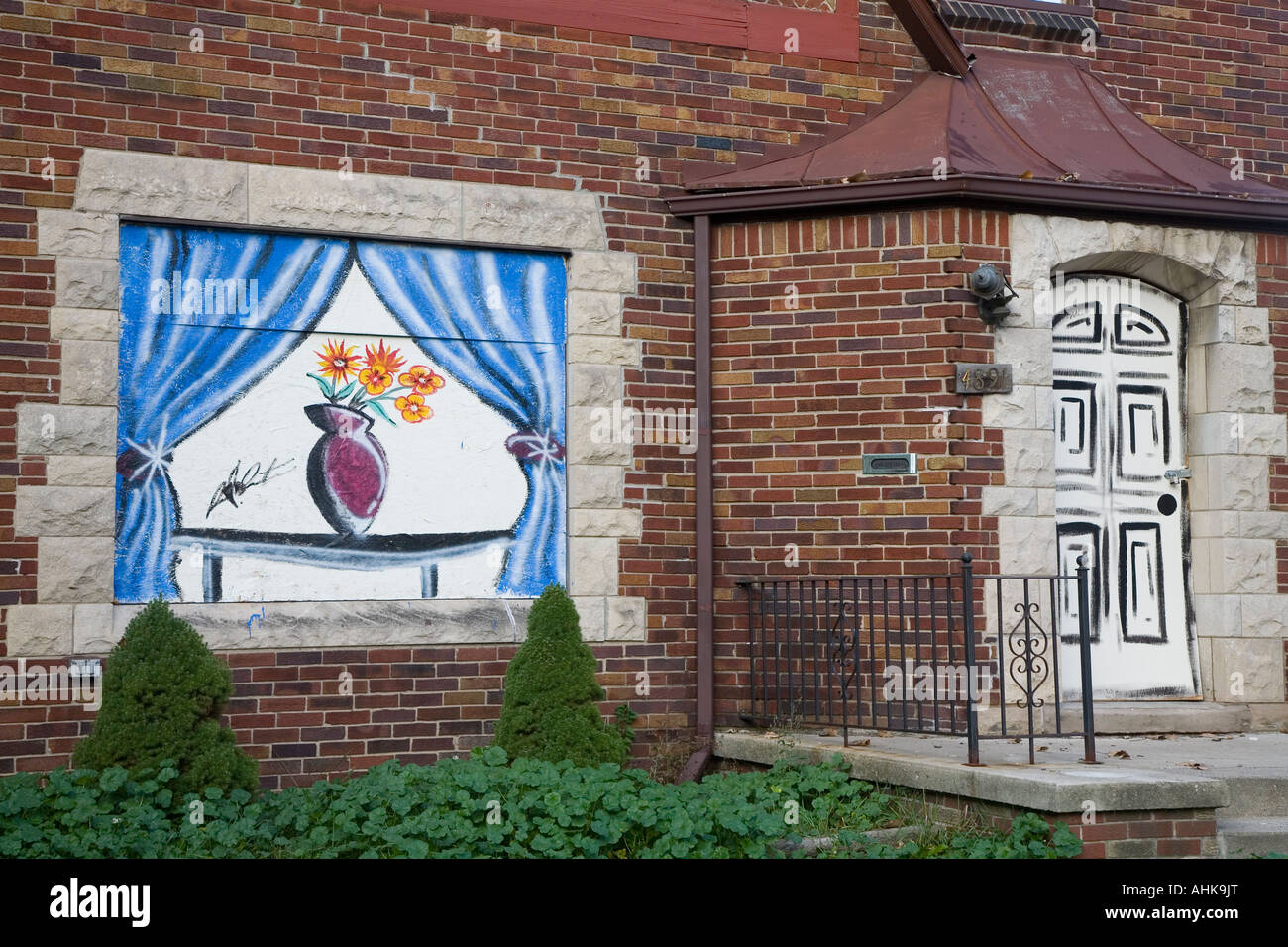 Neighbors paint door and window of boarded-up house Stock Photo - Alamy