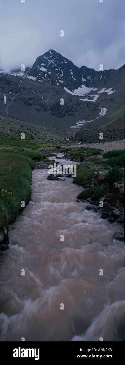 Chile El Morado National Park Stream rushes through meadow at base of ...
