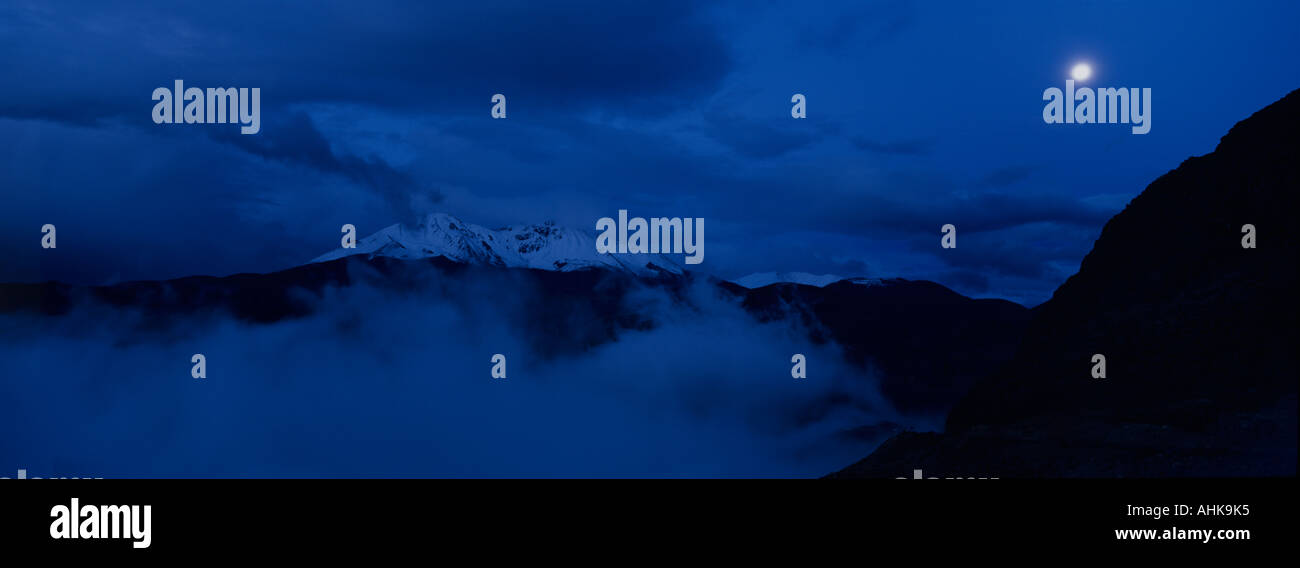 Chile Moon rises above evening fog rolling into valley in Andes ...