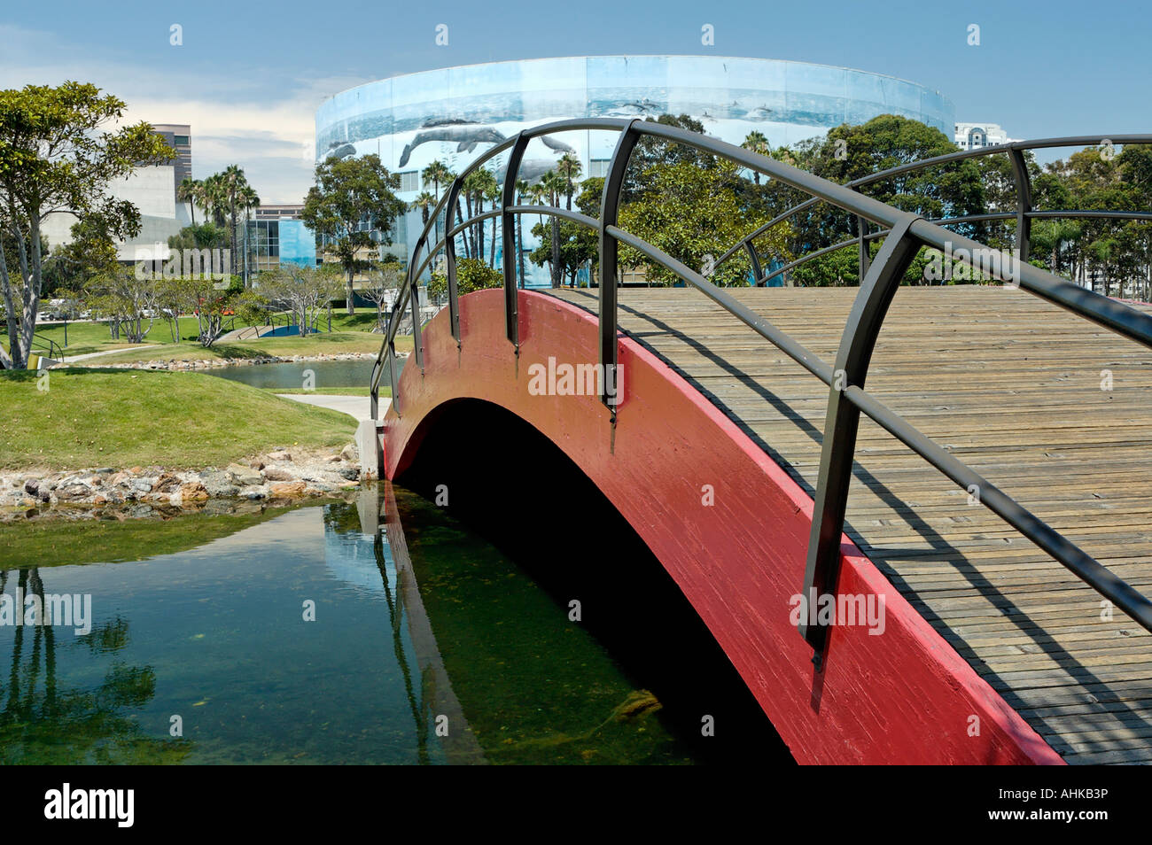 Pedestrian bridge in Rainbow Lagoon Park with the Long Beach Arena in ...