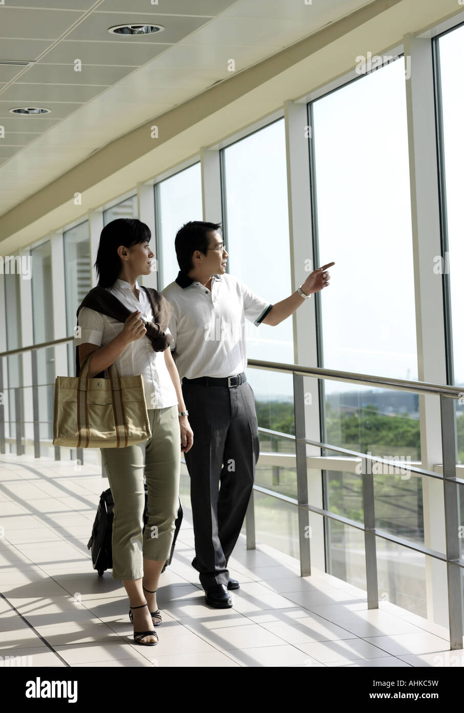 Couple walking down corridor Stock Photo - Alamy