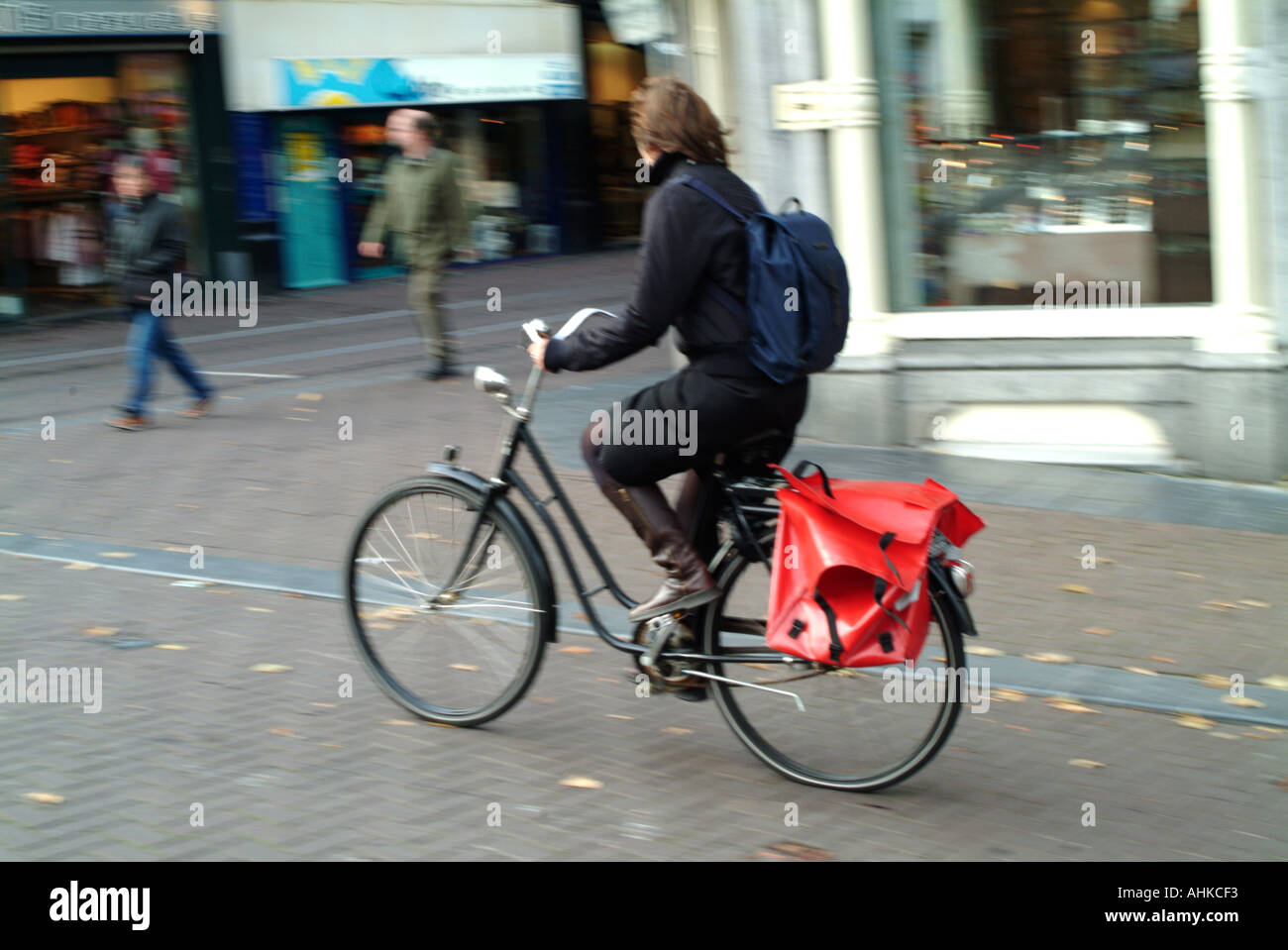 Riding bicycle in Amsterdam Netherlands Stock Photo - Alamy