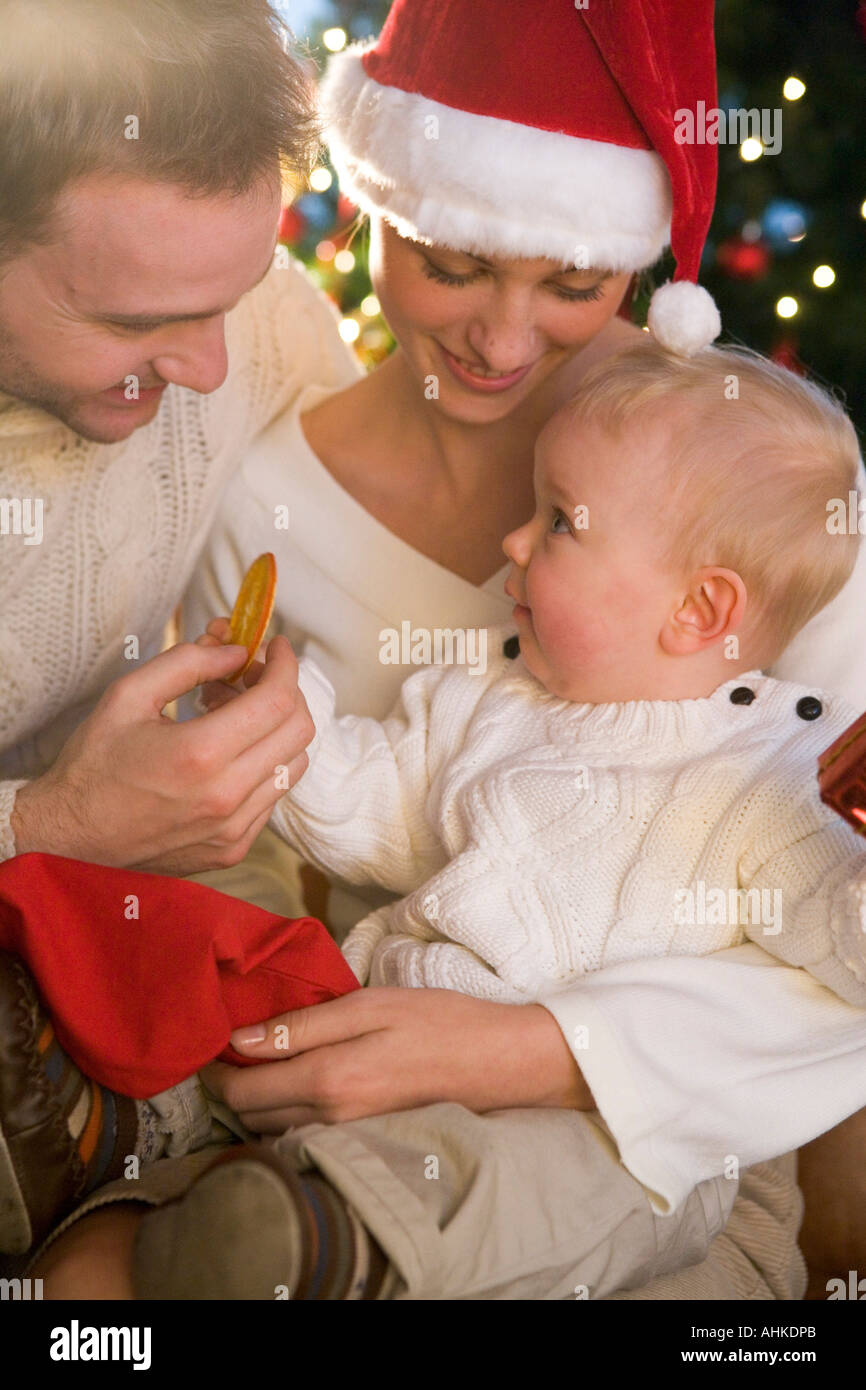 Baby christmas tree family feast fun happy infant hi-res stock ...