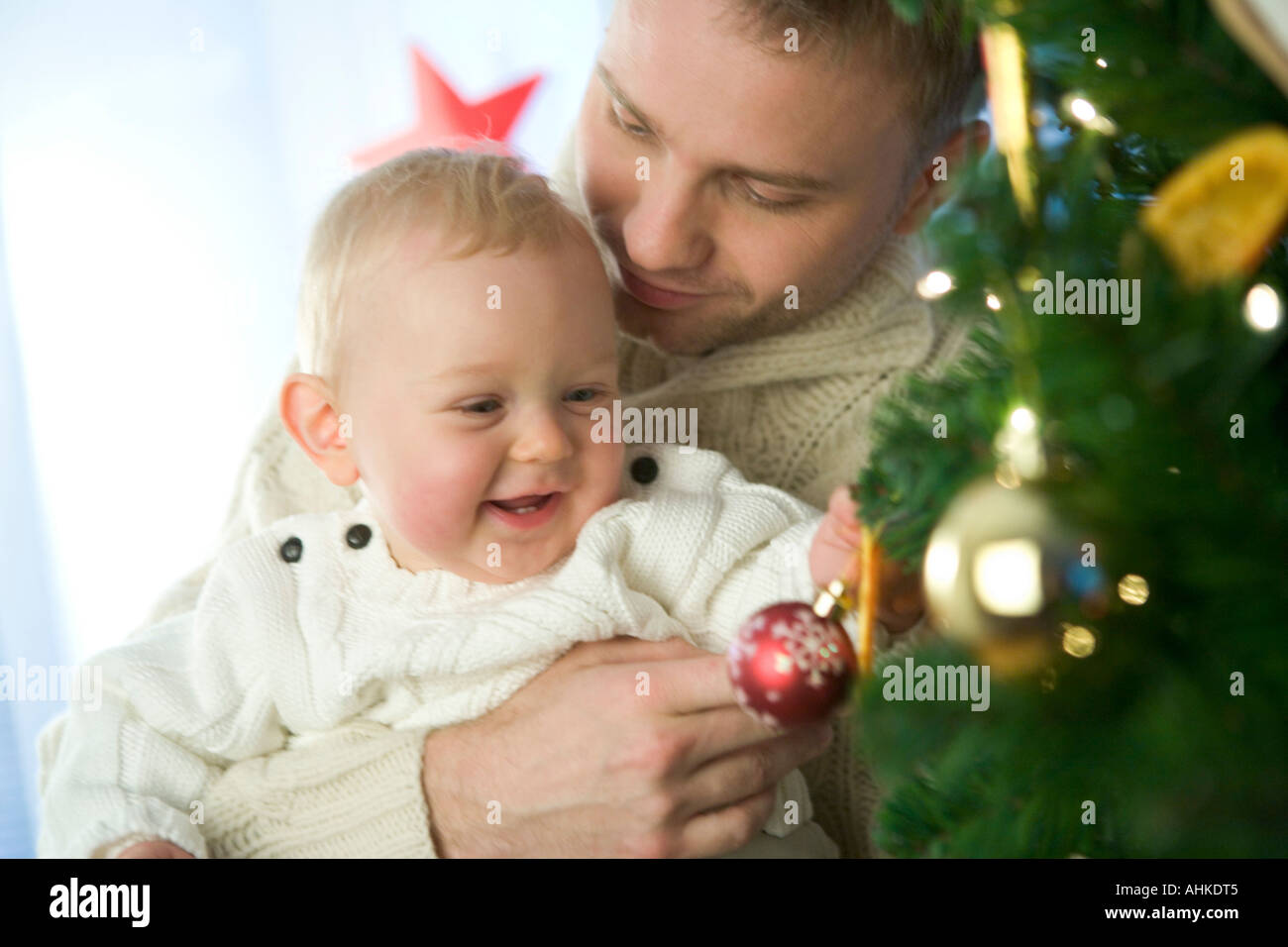 Baby christmas tree family feast fun happy infant hi-res stock ...