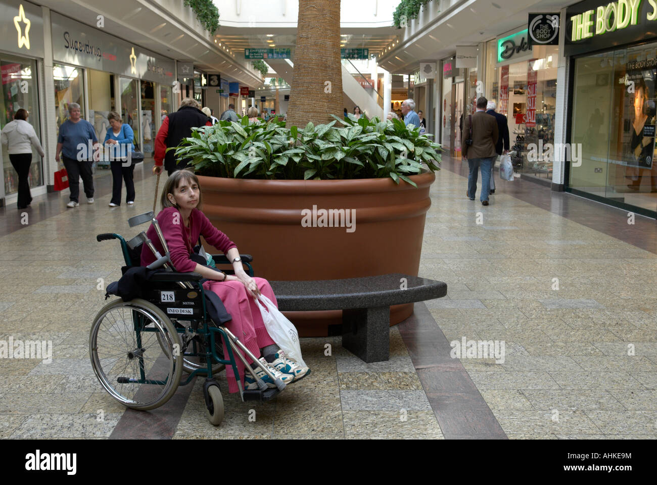 Infirm lady sitting alone in a wheelchair in a shopping centre - LADY ...