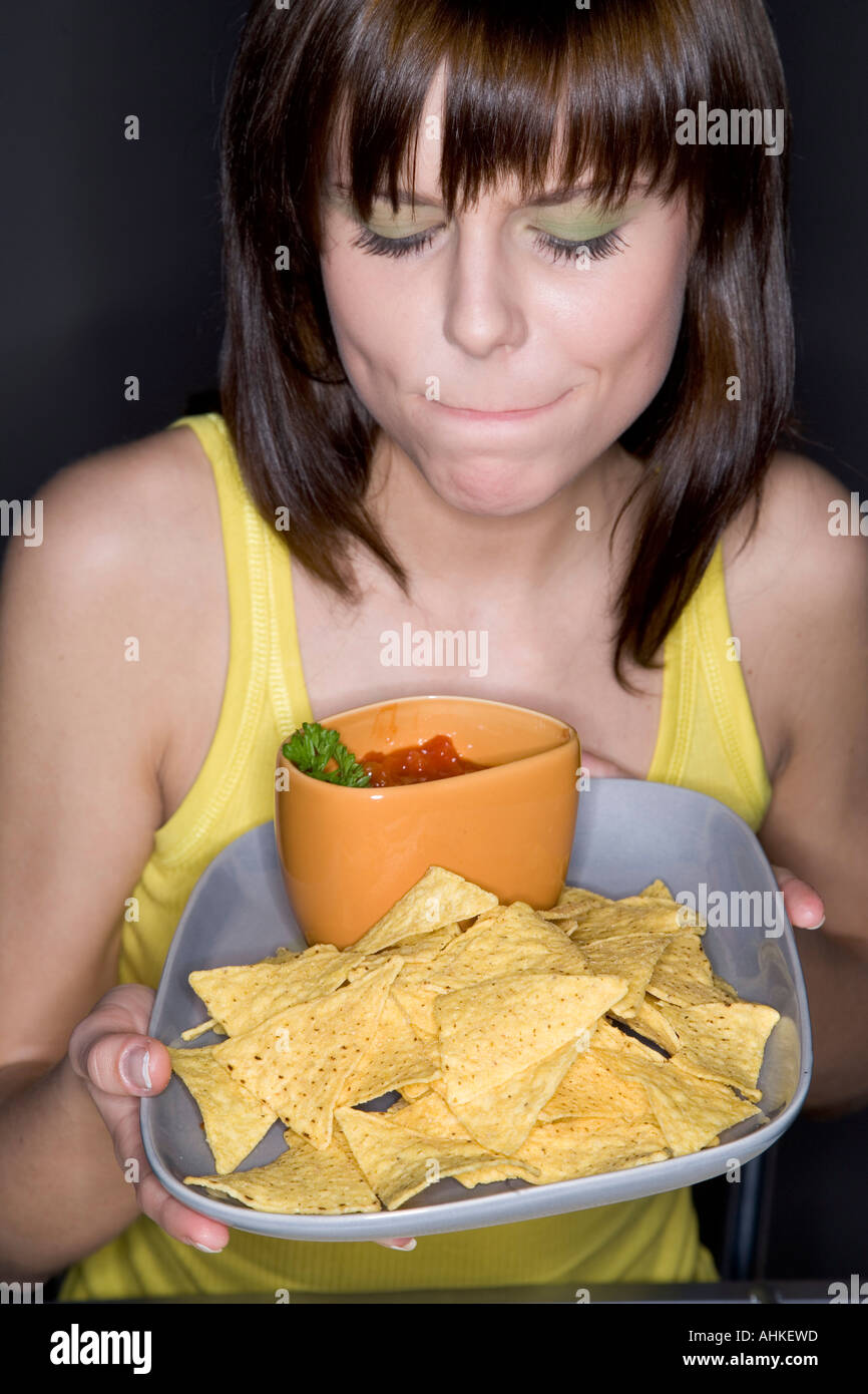 woman eating tortilla chips with salsa Stock Photo - Alamy