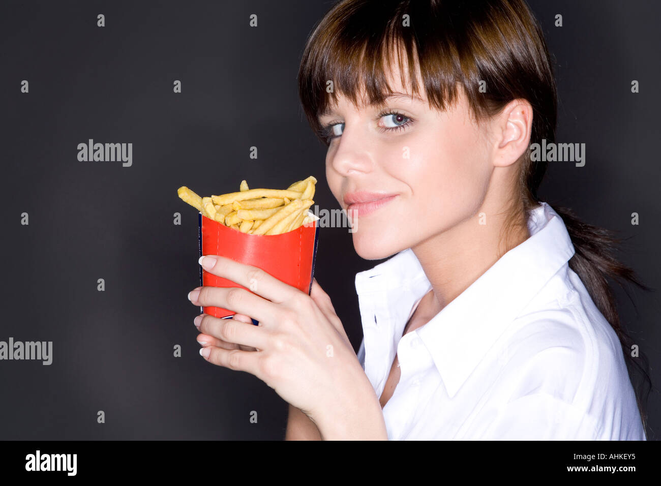 young woman with fries Stock Photo - Alamy