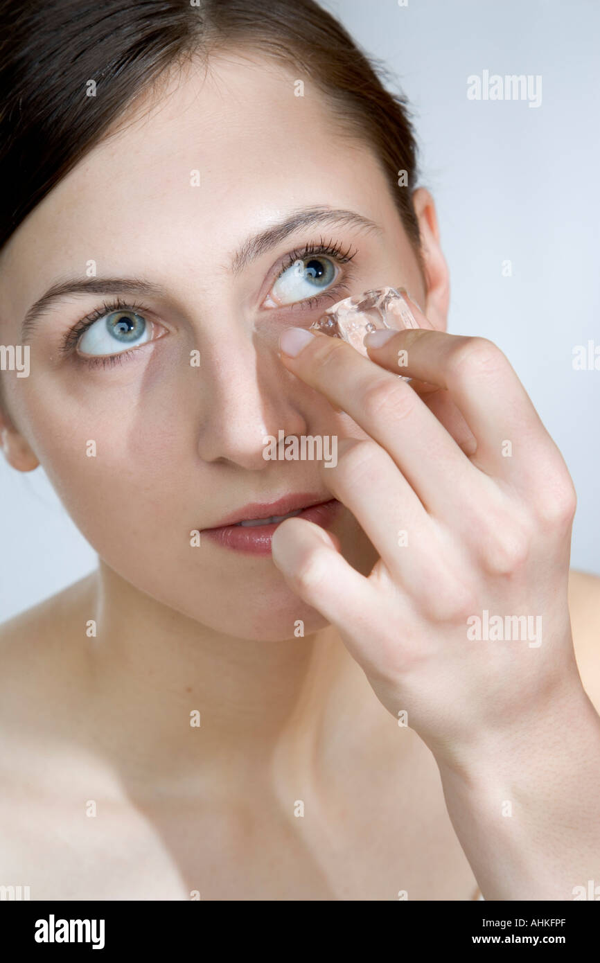 young woman touching face with ice cube Stock Photo - Alamy