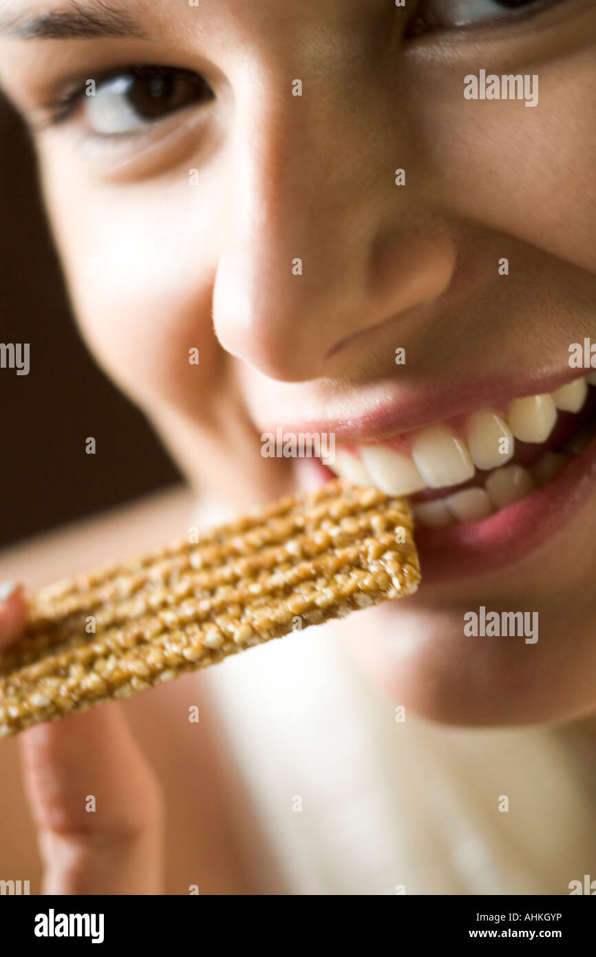 woman biting snack Stock Photo - Alamy