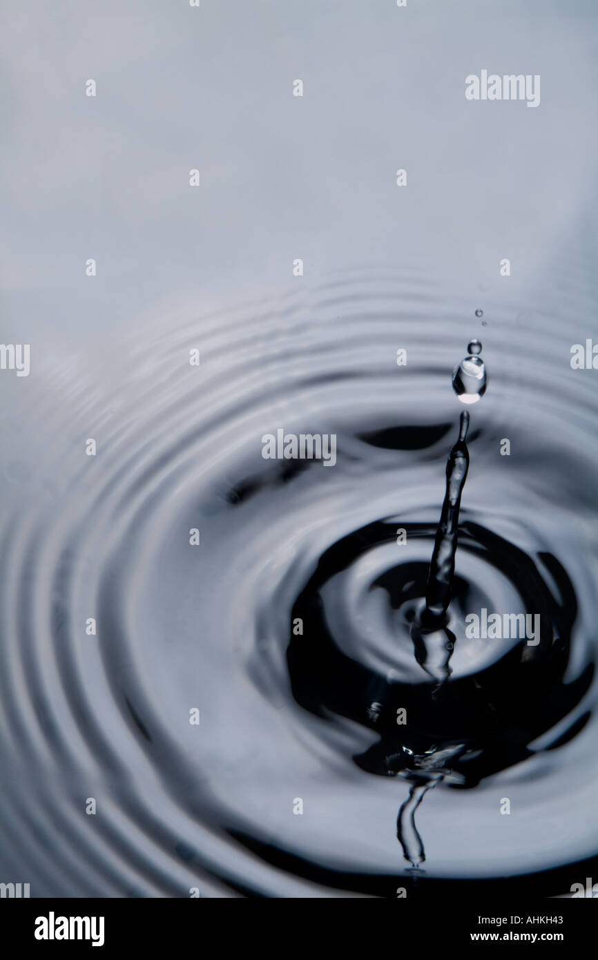 Water droplet splashing up from surface Stock Photo - Alamy