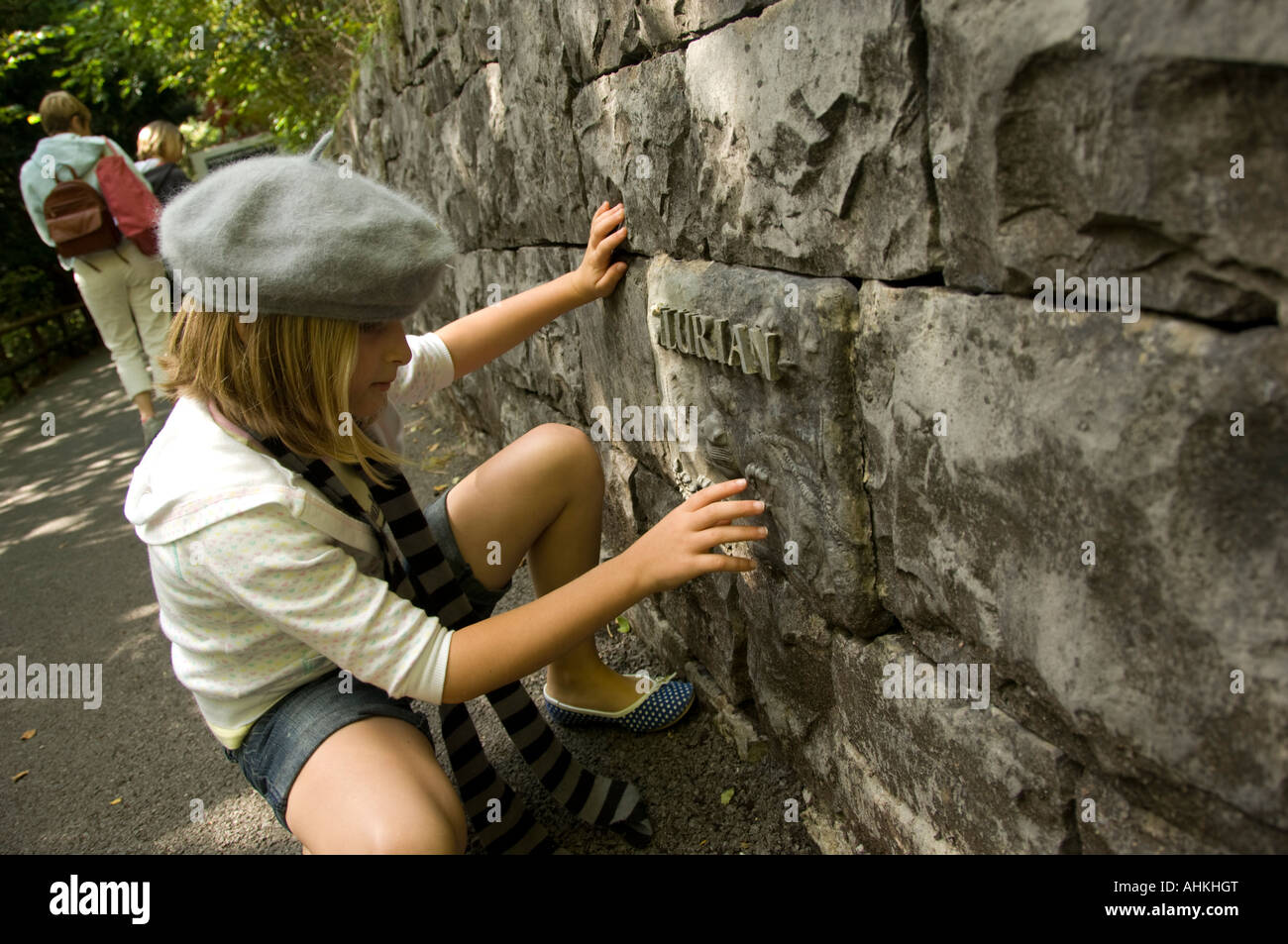 child looking at rock wall at Dan yr Ogof national showcaves of Wales ...