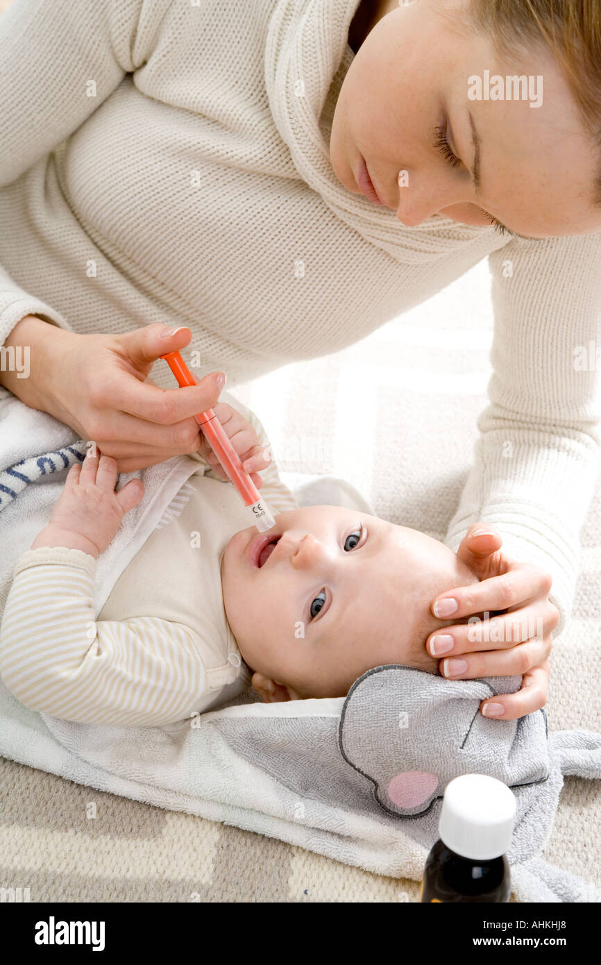 Mom giving daughter medicine hi-res stock photography and images - Alamy