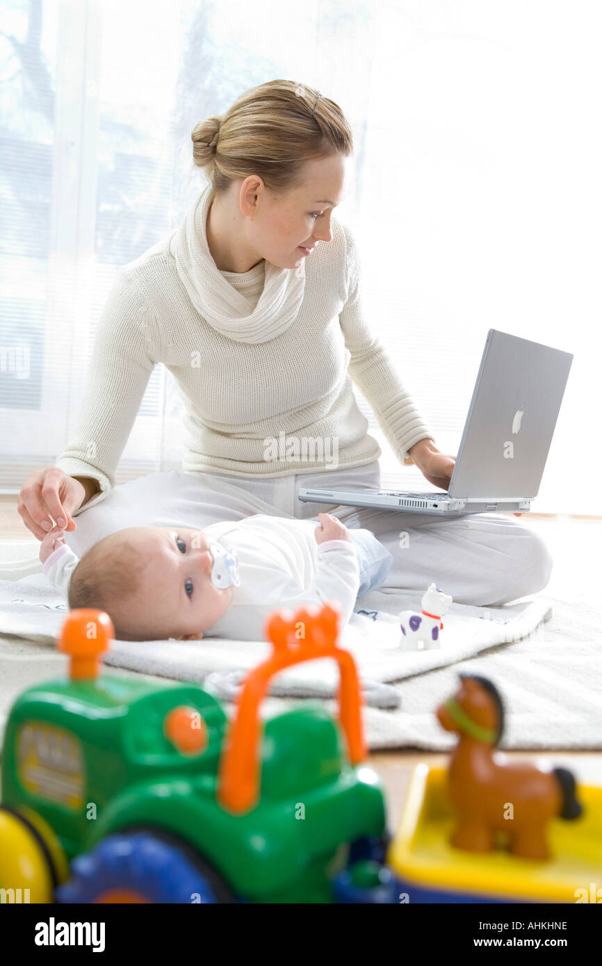 Busy mother working taking care hi-res stock photography and images - Alamy